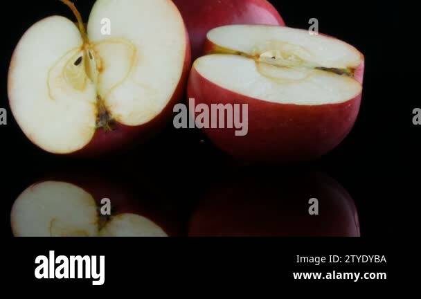 Beautiful ripe juicy red apples on the mirror surface and black ...