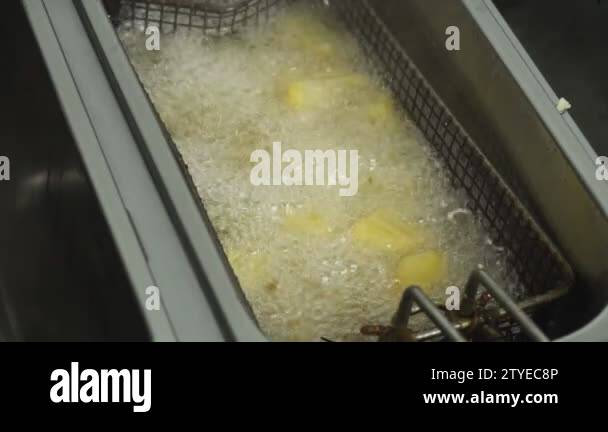 reuse of vegetable oil that boils in restaurant deep fryer in slow ...
