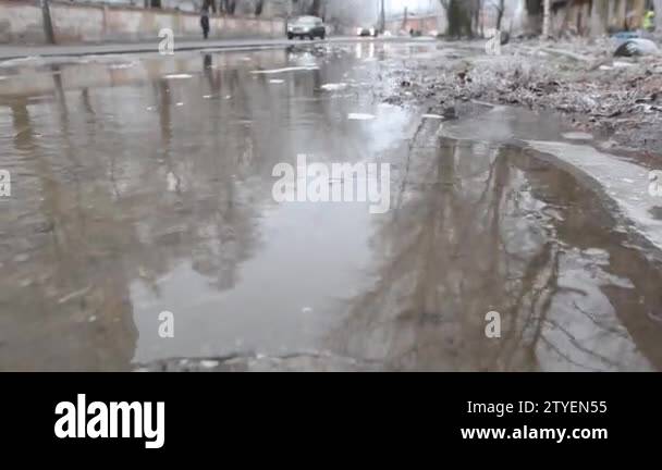 Car traffic on the flooded city street during heavy rain, heavy ...