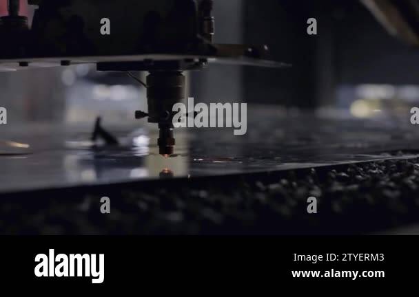 The CNC laser cut machine while cutting the sheet metal with the ...