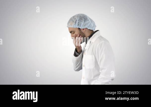 Doctor man walking stressed with hand on head, shocked with shame and ...