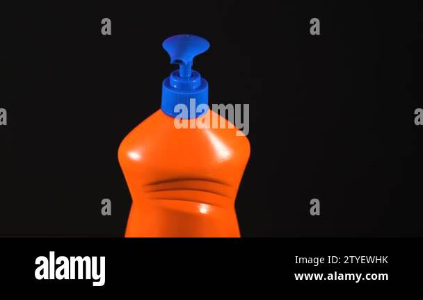 Orange bottle of detergent. Bottle without labels and name. Hand ...