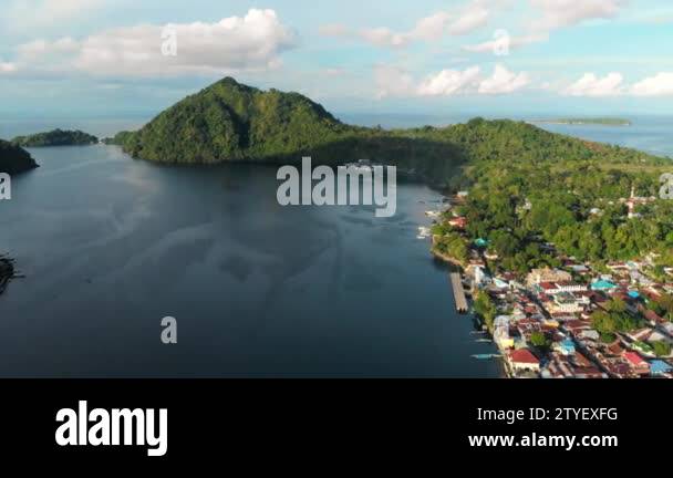 Aerial: flying over Bandaneira village at sunset Indonesia Banda ...