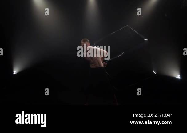 circus male muscular performer making tricks with juggling cube props ...