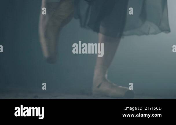 Close up of female slim legs standing in pose and make steps on black ...