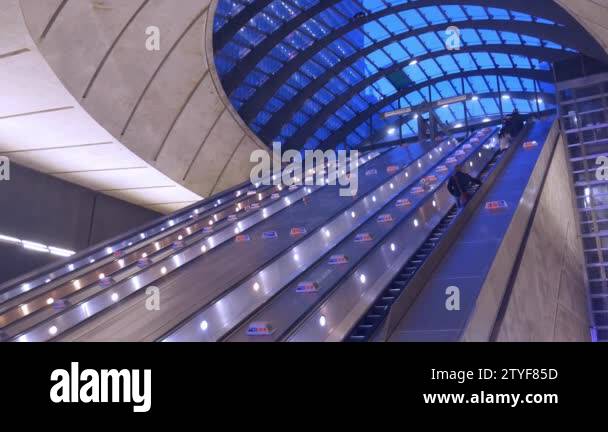 Looking up perspective of people going up escalator at Londons Canary ...