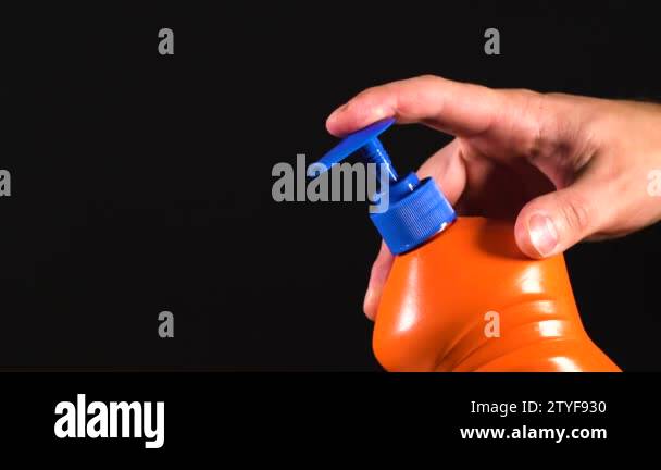 Orange bottle of detergent. Bottle without labels and name. Hand ...