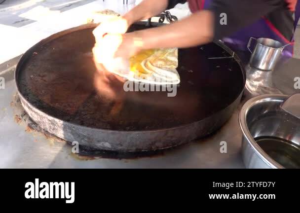 Roti Making, roti thresh flour by roti maker with oil and butter. Asian ...