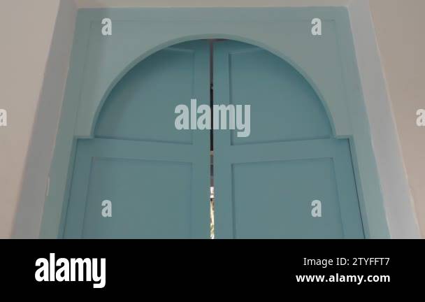 Double-leaf or double doors opening slowly revealing part of Arabic ...