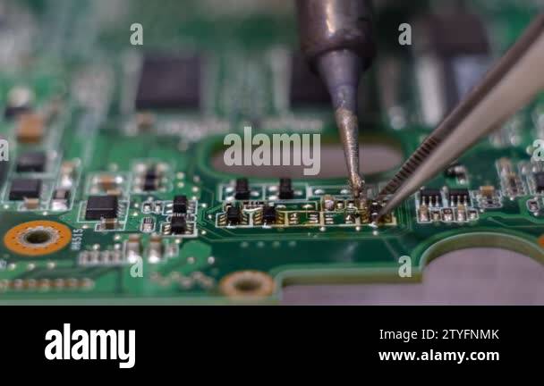 Soldering electronic circuit boards and parts in the laboratory Stock ...