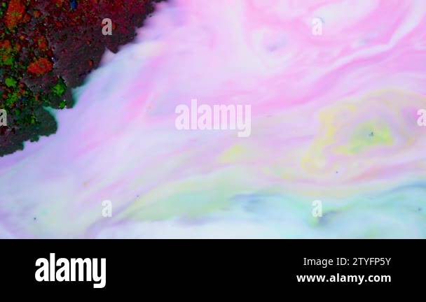 Rainbow stains on milk. Colorful pastel colors paint streaks on surface ...