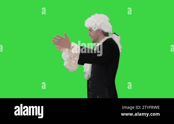 Man dressed like Wolfgang Amadeus Mozart conducting an orchestra on a ...