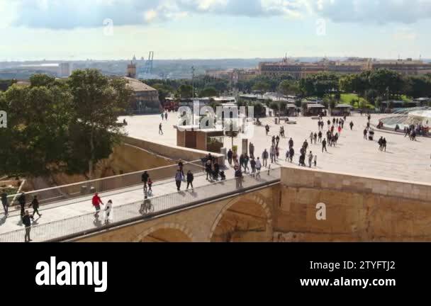 The Triton fountain in Valletta, Malta. People on the square, bridge ...