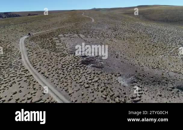 Aerial drone scene of 4x4 van driving at track off road at golden ...