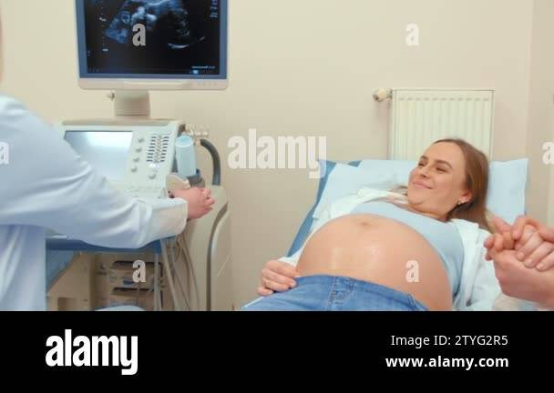 A doctor transmits a photograph of ultrasound scanning a happy couple ...
