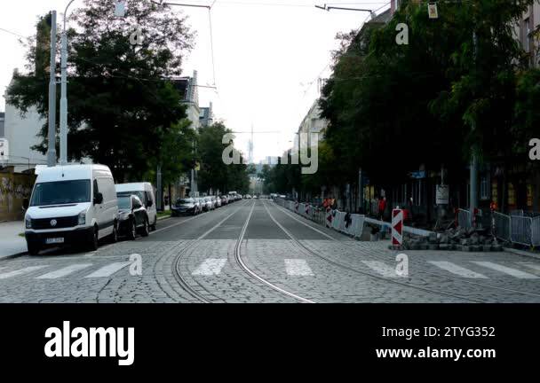 Billboard - green screen - urban street with passing cars and trams and ...