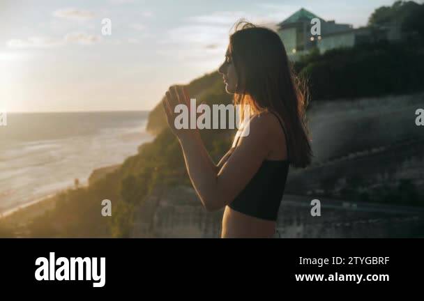 Peacefull girl praying looking up at orange sky with hope, close-up ...