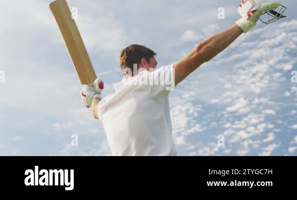 Low angle front view of a teenage Caucasian male cricket player wearing ...