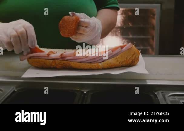 The process of making a big king size meat sandwich with ham and salami ...