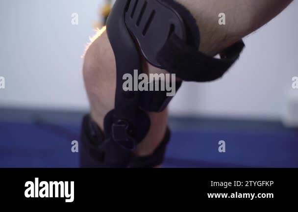 Detail of the lower half of man adjusting a supportive leg brace Stock ...