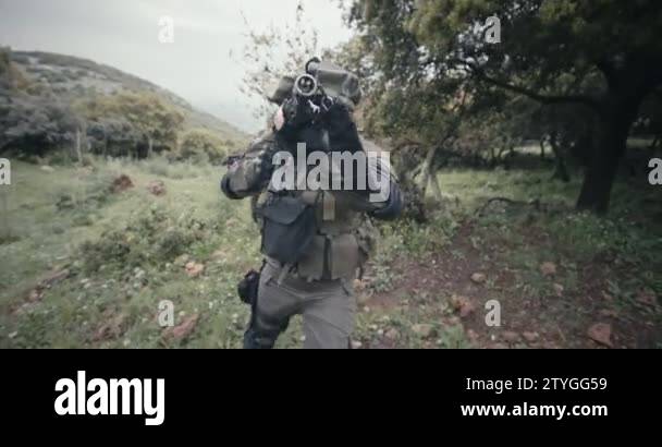 Squad of fully armed commando soldiers during combat in a forest ...