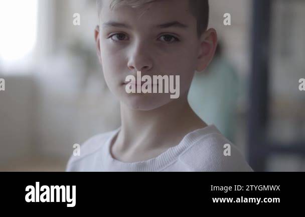 Close up face of a young man cute handsome teenager serious boy looking ...