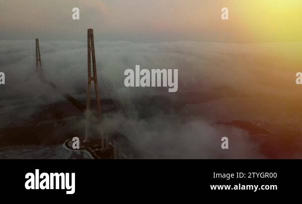 Flying backwards, aerial ascending view of cable-stayed Russian bridge ...