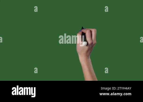 Green screen. Chromakey. Female right hand writes a marker on the wall ...