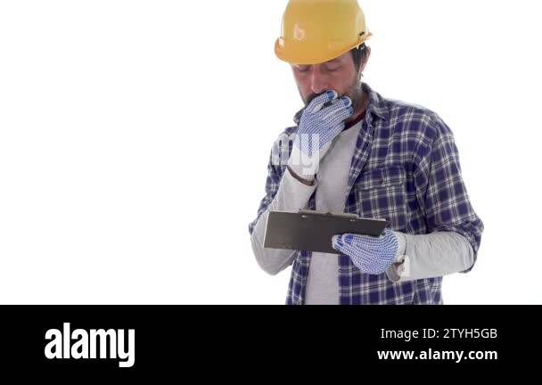 Construction worker writing project notes on clipboard notepad ...
