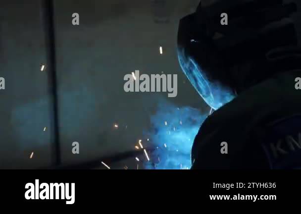 Welder working with welding machine. Bright flashes and smoke.. Welding ...