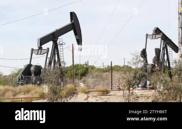 Industrial urban landscape. La Brea Inglewood in Los Angeles. Well pump jack operating behind ...