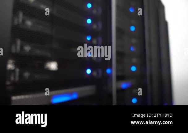 Data center, server room in a blurry background. Blinking blue led ...