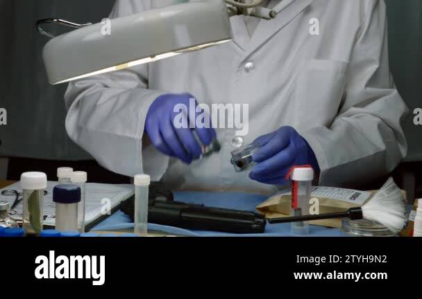 Scientific police examining and making photos of a bullet cap in ...