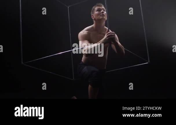 circus male muscular performer making tricks with juggling cube props ...