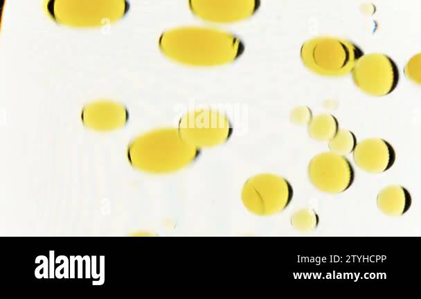 drops of oil entering the water forming animated textures, footage ...