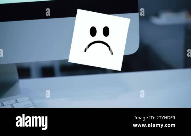Sad smile. Sad face painted on a sticker on the monitor. Message ...