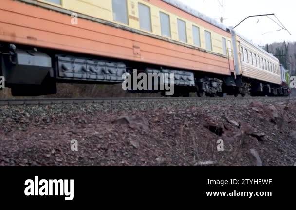 Electric train with old passenger cars covered with old paint and rust ...