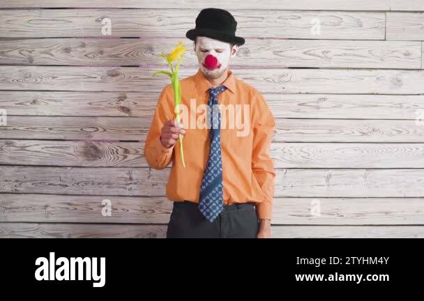 Clown with tulip flowers in funny concept. Man in love on a date ...
