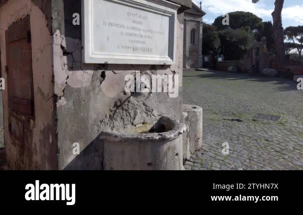 Ostia Antica village with the ancient medieval fountain and Sant'Aurea ...