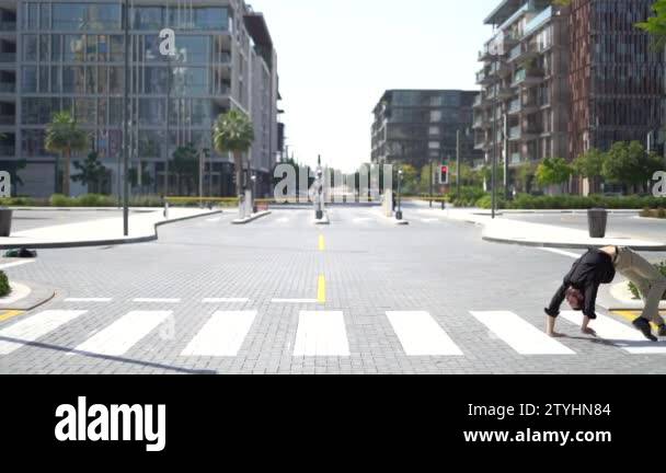 flexible rubber man wearing as Businessman crossing crosswalk upside ...