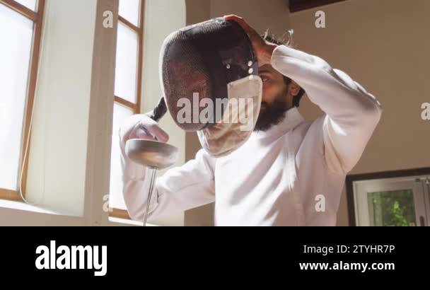 Low angle side view of a confident focused mixed race male fencer ...