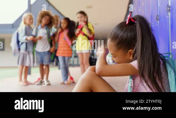 Schoolkids bullying a crying Asian girl in the corridor of elementary ...