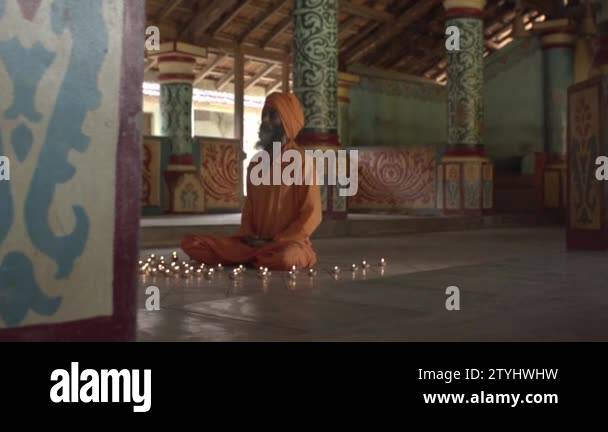 A monk in an ancient temple lights a sacred fire, the priestess brought ...