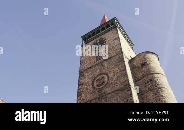 Medieval Renaissance square with stone tower and clock. View to row of ...