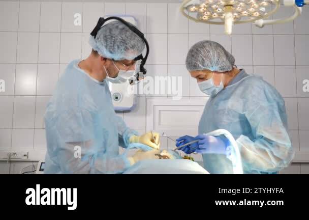 Dental treatment in dentistry clinic during surgery operation. Dentist ...