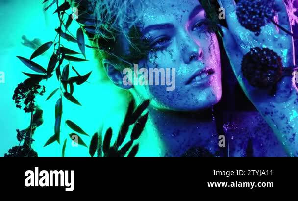 a very beautiful haute couture model with makeup posing in neon glows ...