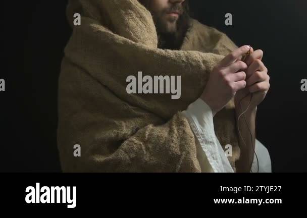 Jesus in robe showing Christian cross, crucifixion symbol, dark ...