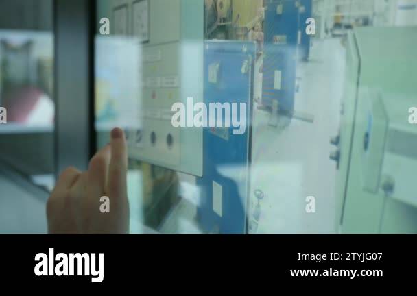 Female hand pressing the icons on a huge vertical monitor on a merchant ...