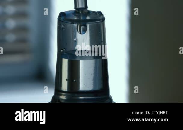 Transparent dropper with medical liquid dribbling down in an airy ...