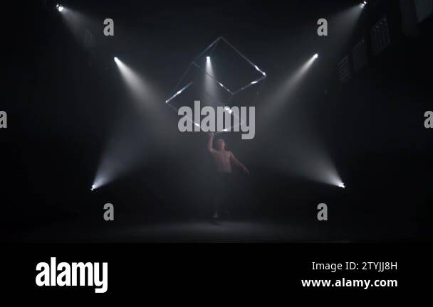 circus male muscular performer making tricks with juggling cube props ...